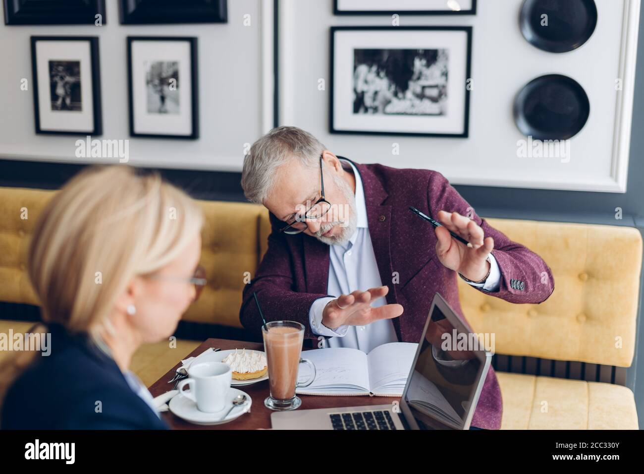 talented successful businessman is teaching a woman to work with a ...