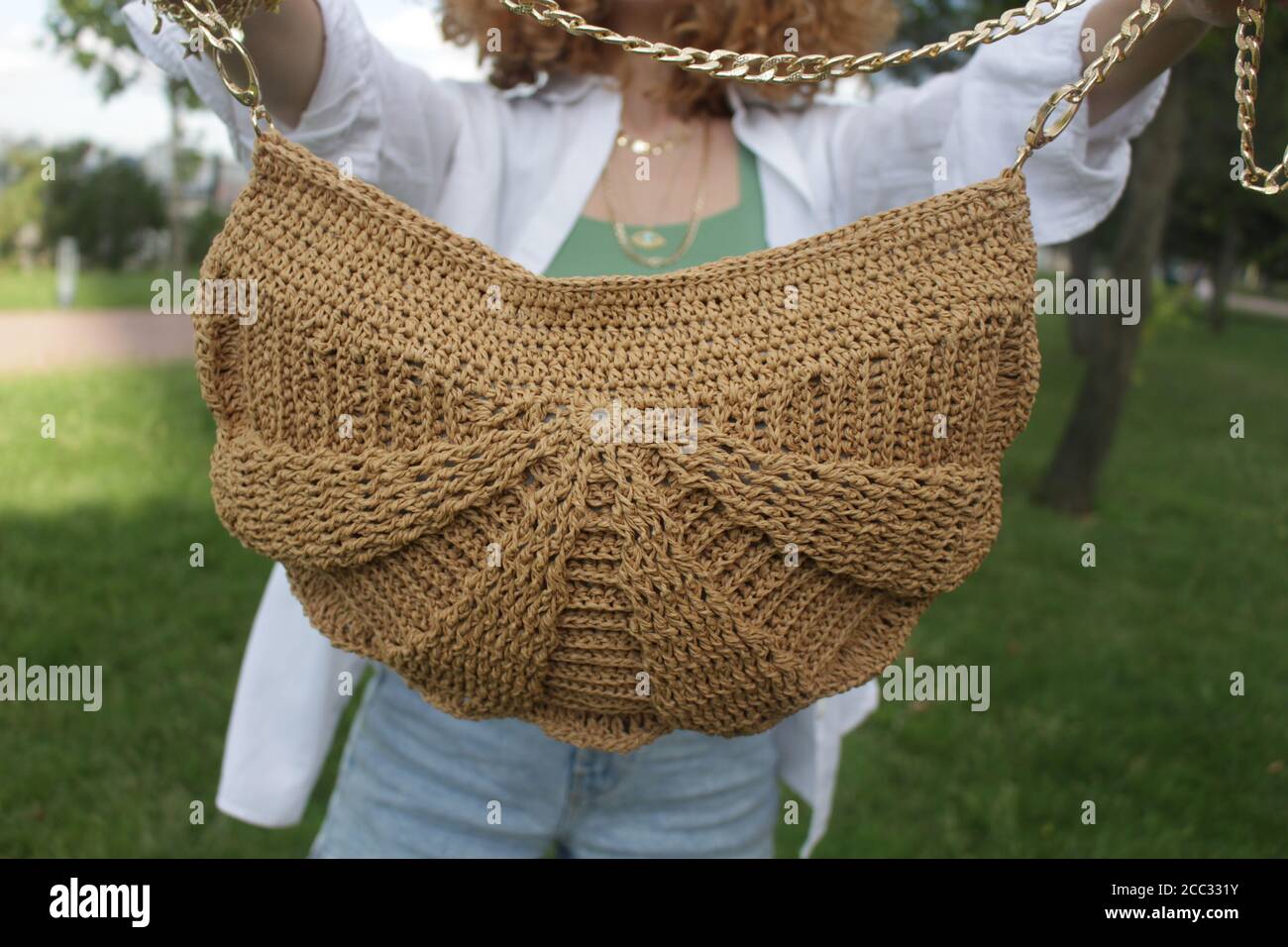 girl showing straw bag Stock Photo - Alamy