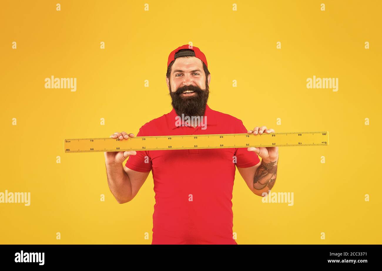 happy about size. Bearded man with big measuring instrument. Measuring ...