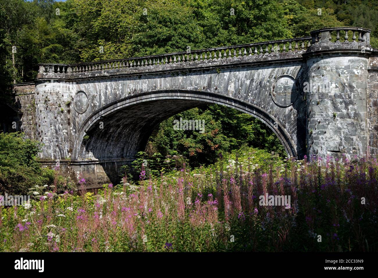 Ancient stonework bridge spanning a highland river in Scotland Stock ...