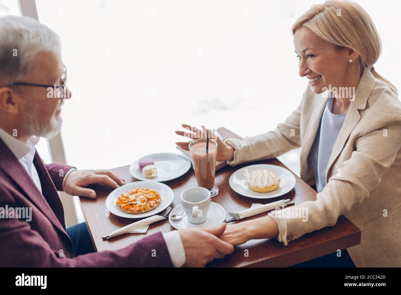romantic couple sharing tender moments in the cafe. close up side view ...
