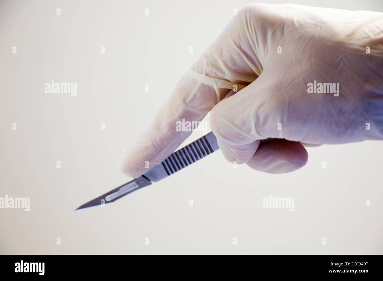 Surgery knife holding on the white background, studio shot. Operation ...