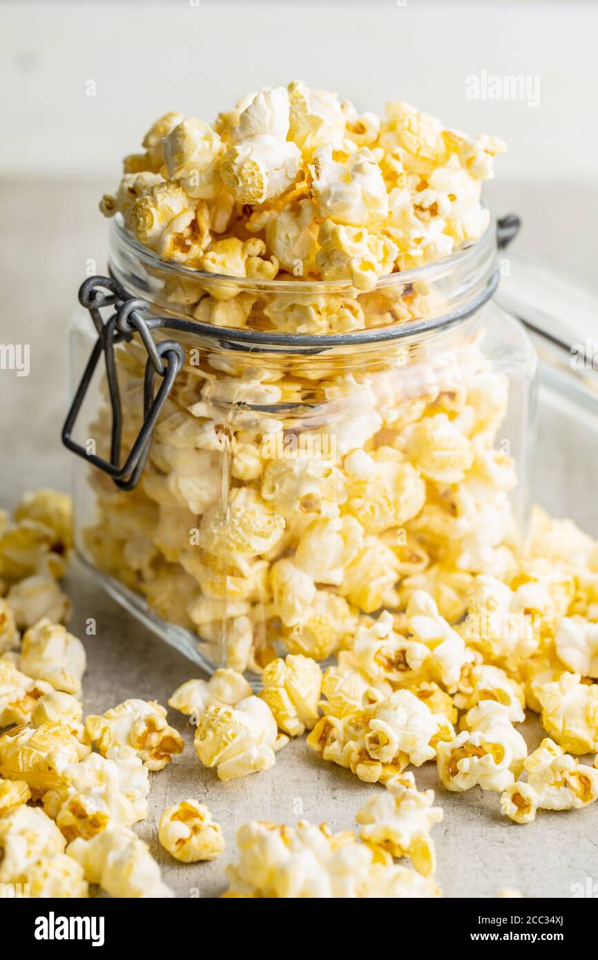 Sweet tasty popcorn in jar on kitchen table Stock Photo - Alamy