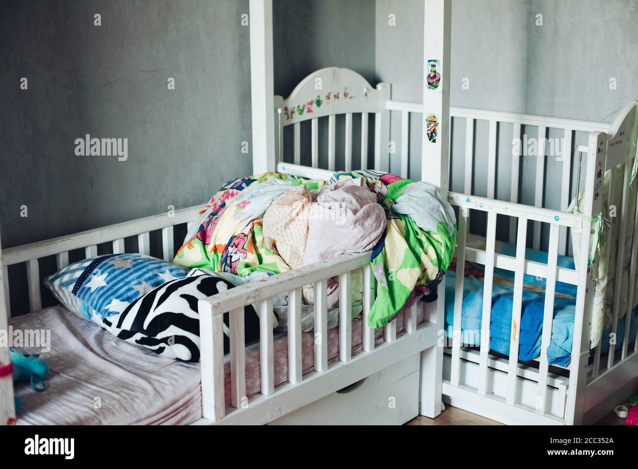 Fragment of a photo of a children's room with scattered things, pillows ...