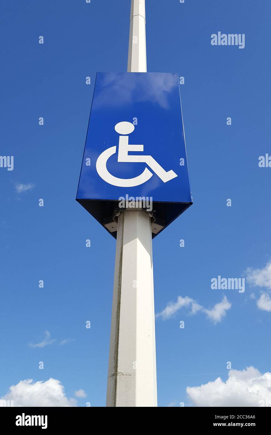 mast with a road sign with a parking space reserved for the disabled ...