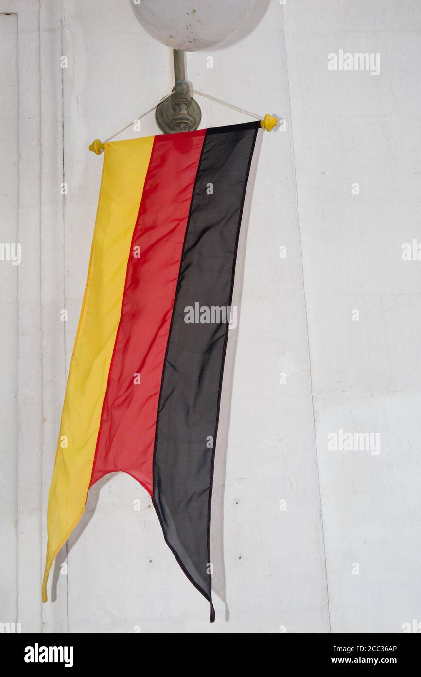 german banner flag on white wall in germany city Stock Photo - Alamy