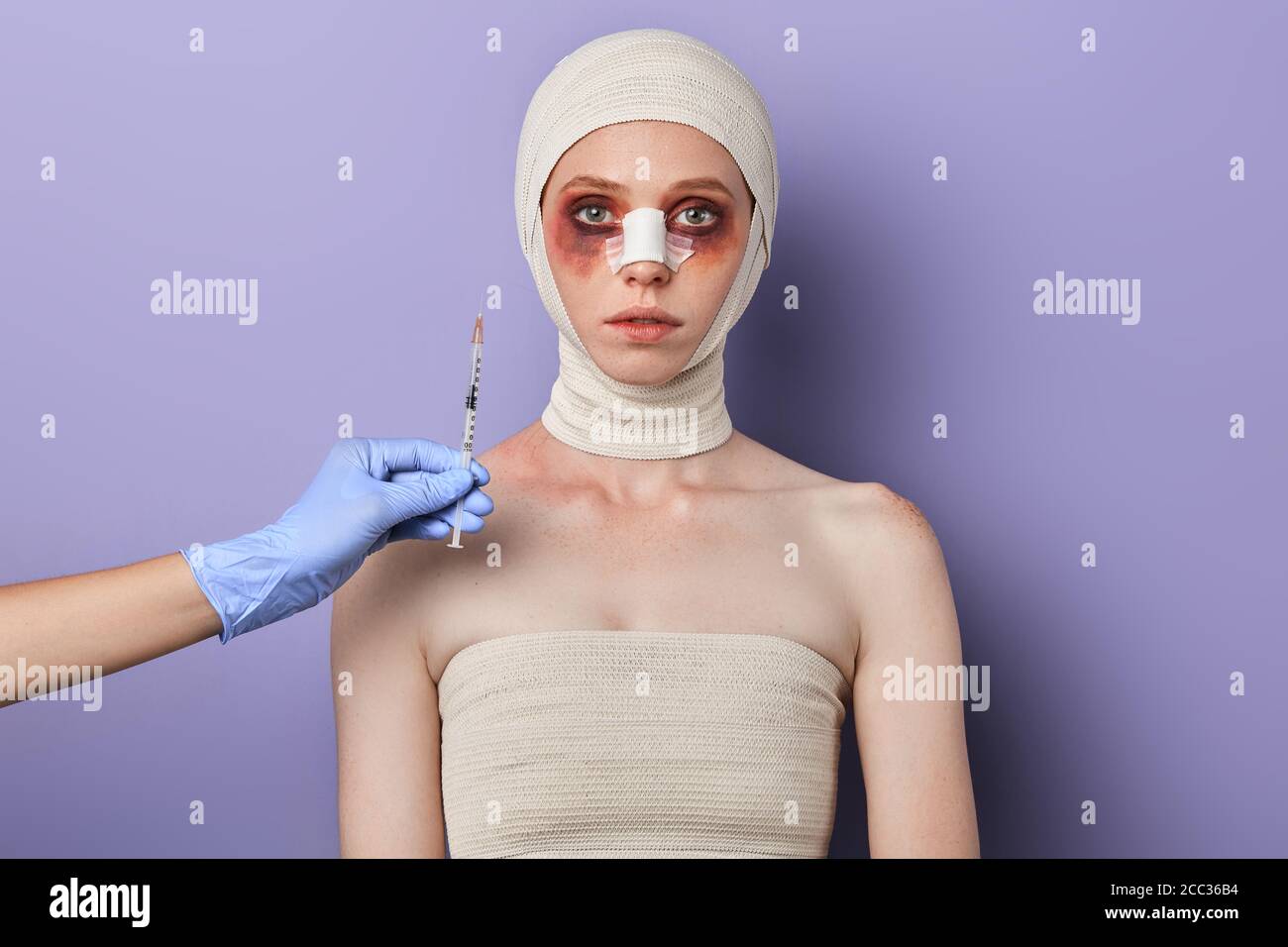 serious woman with black eyes looking at the camera, doctor holding ...