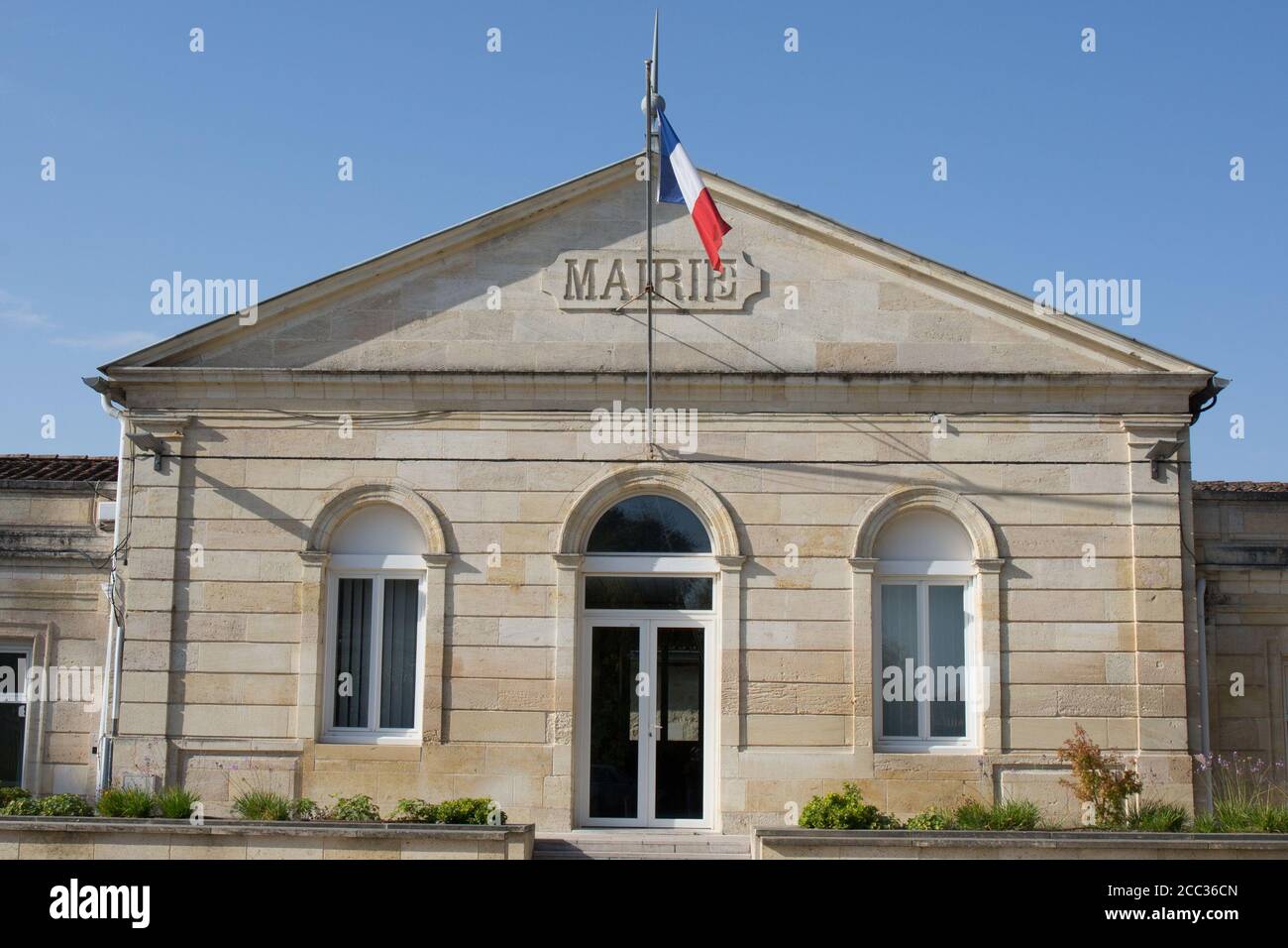 classical town hall in france in summer with flag french Stock Photo ...