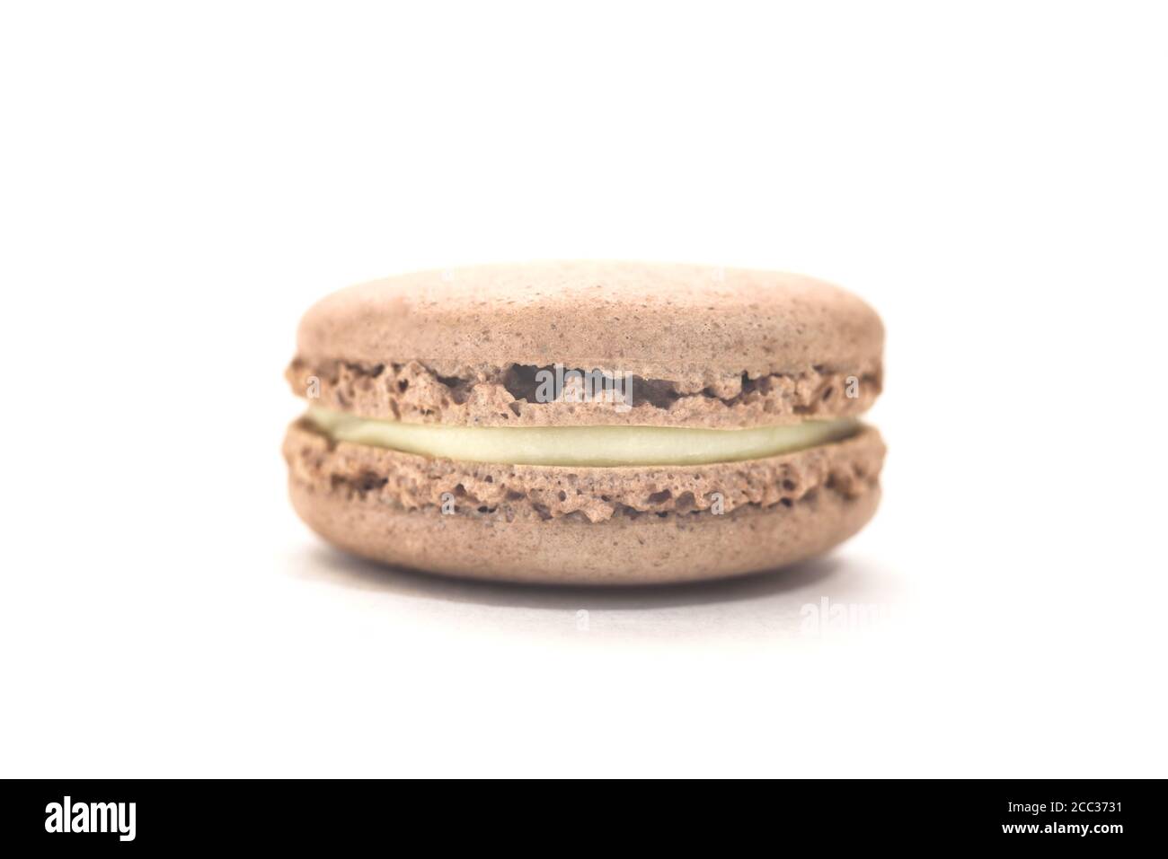 One tasty french chocolate macaron isolated on the white background ...