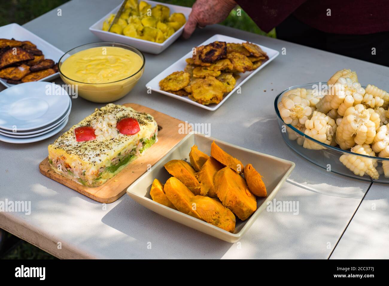 Red sweet potato (camote) and other typical Peruvian dishes on a white ...