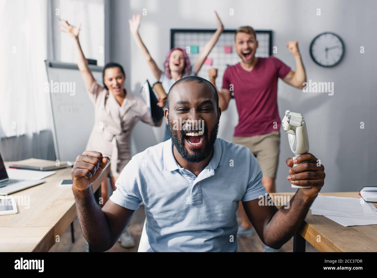 Selective focus of african american businessman showing yeah gesture ...