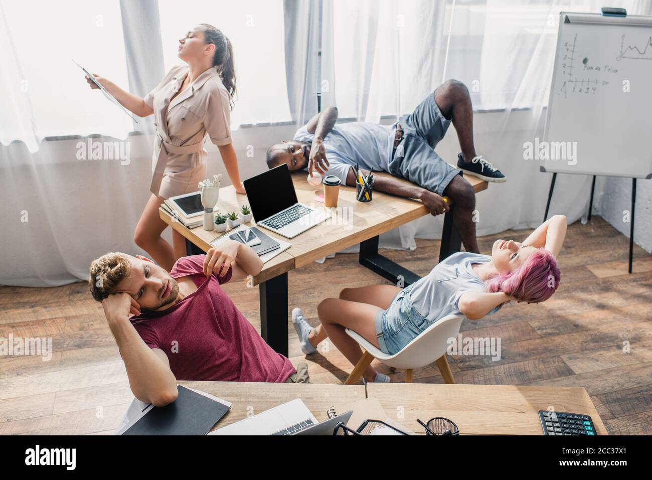 High angle view of multicultural business people feeling hot in office ...