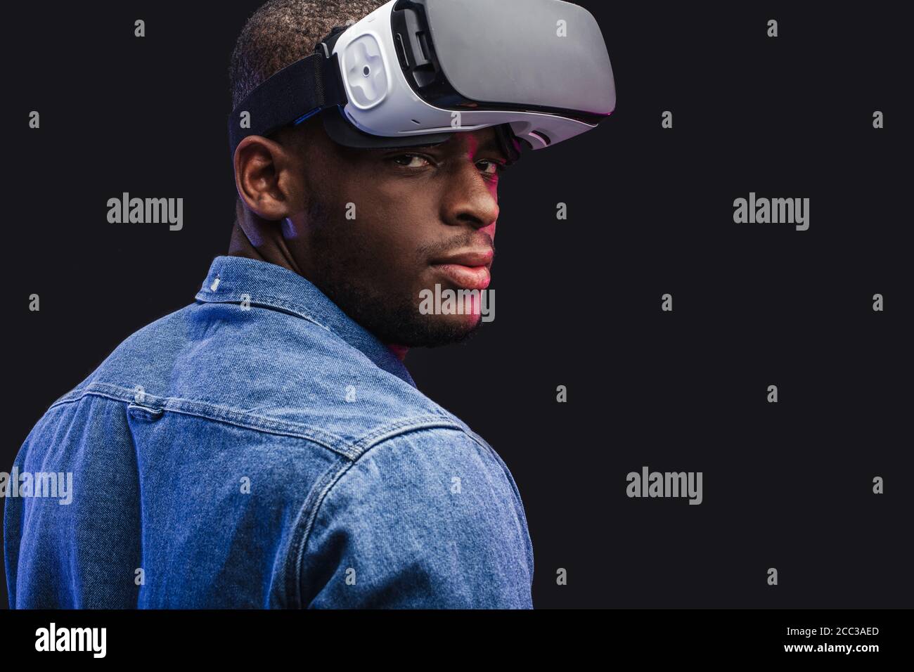 African male architector taking off his virtual reality headset looking ...