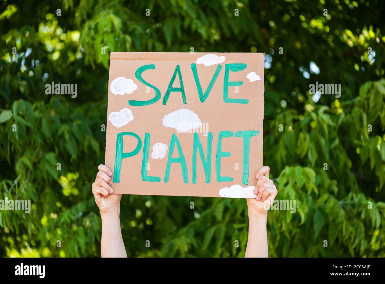 Cropped view of man holding placard with save planet lettering with ...