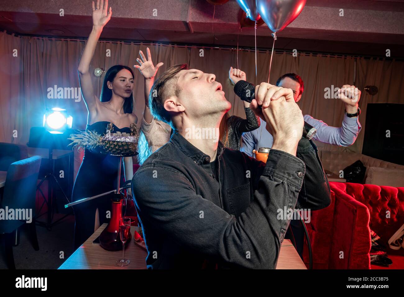 energetic caucasian singer man celebrate birthday in karaoke bar ...