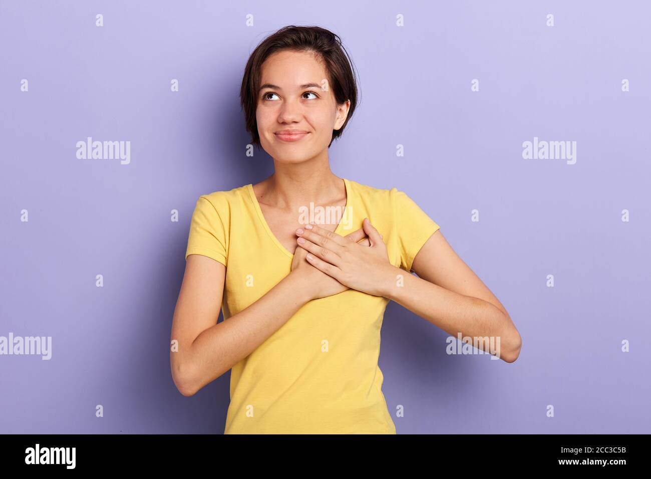 romantic smiling lovely girl expresses her tender feeling, looking up ...