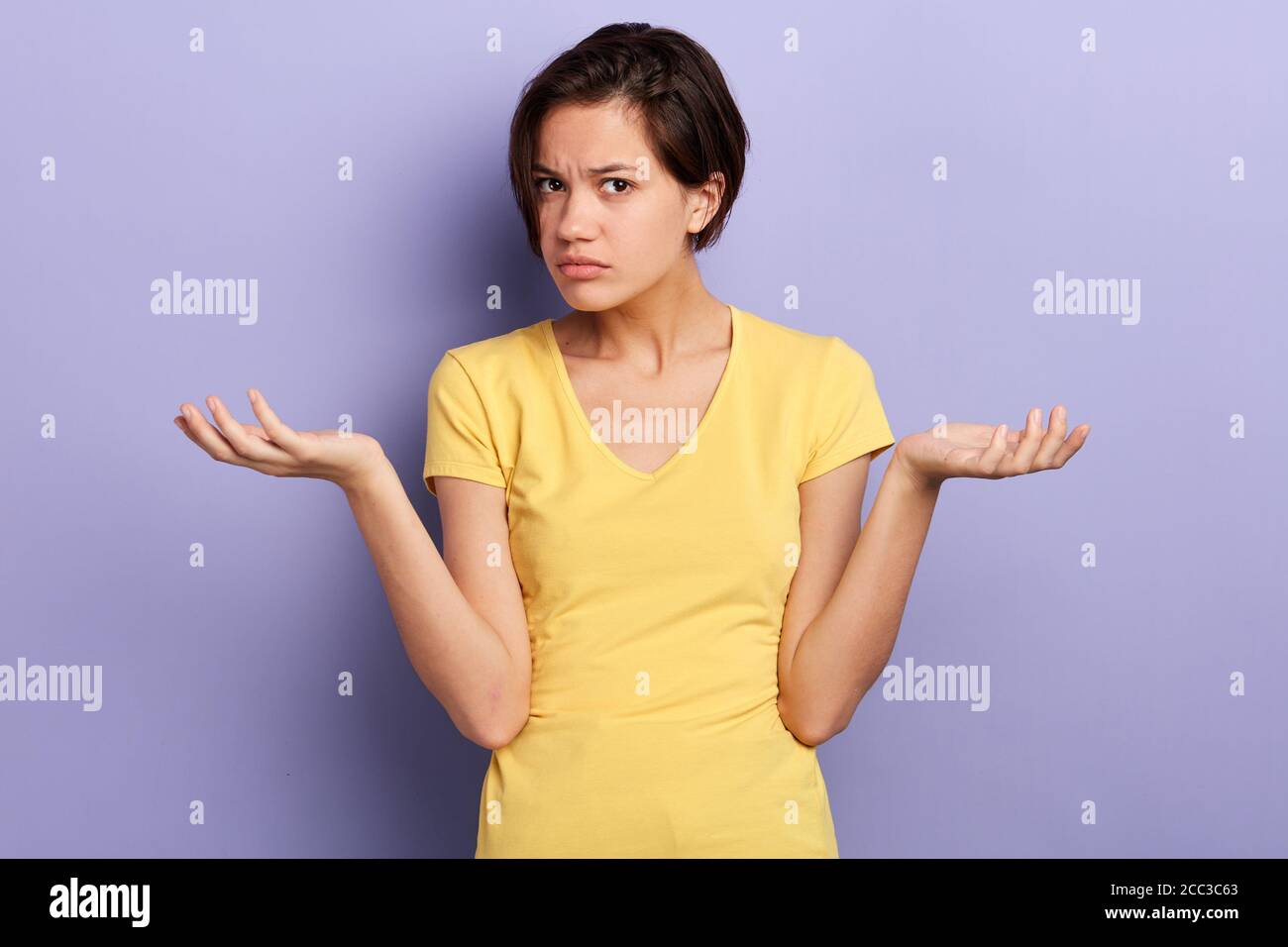 serious girl cannot understand her friend, woman being puzzled with ...