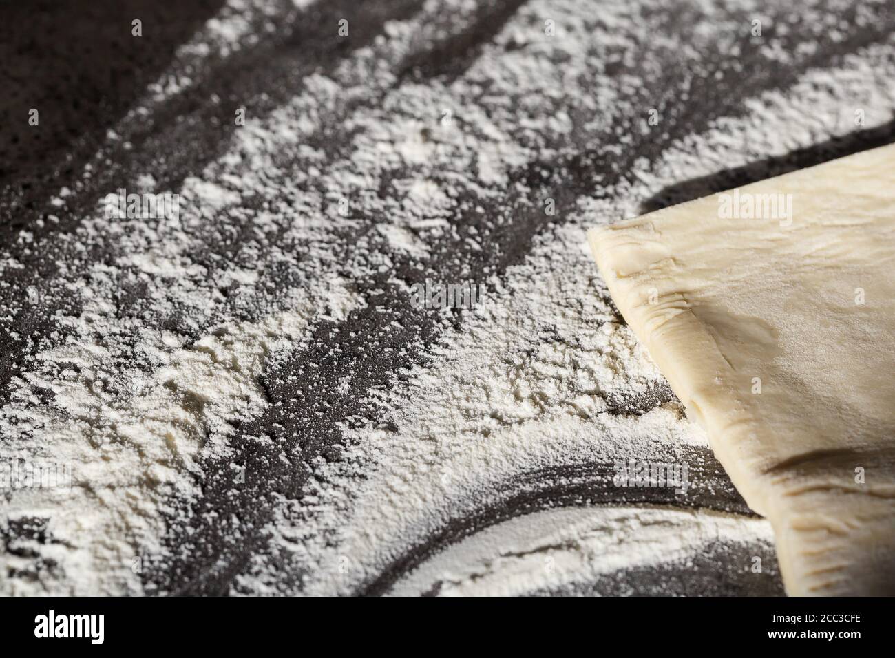 Baking flat lay on the table the dough, flour on a gray background ...
