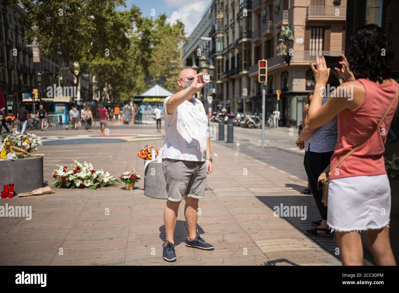 A man poses for a photo, showing a peace sign. Three years after the ...