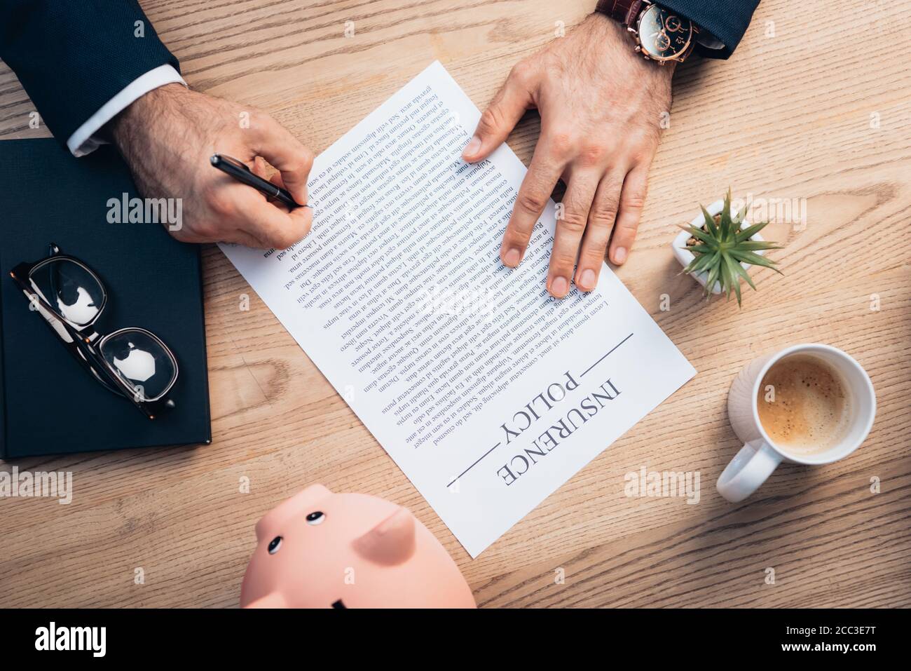 top view of lawyer signing insurance policy agreement near plant ...