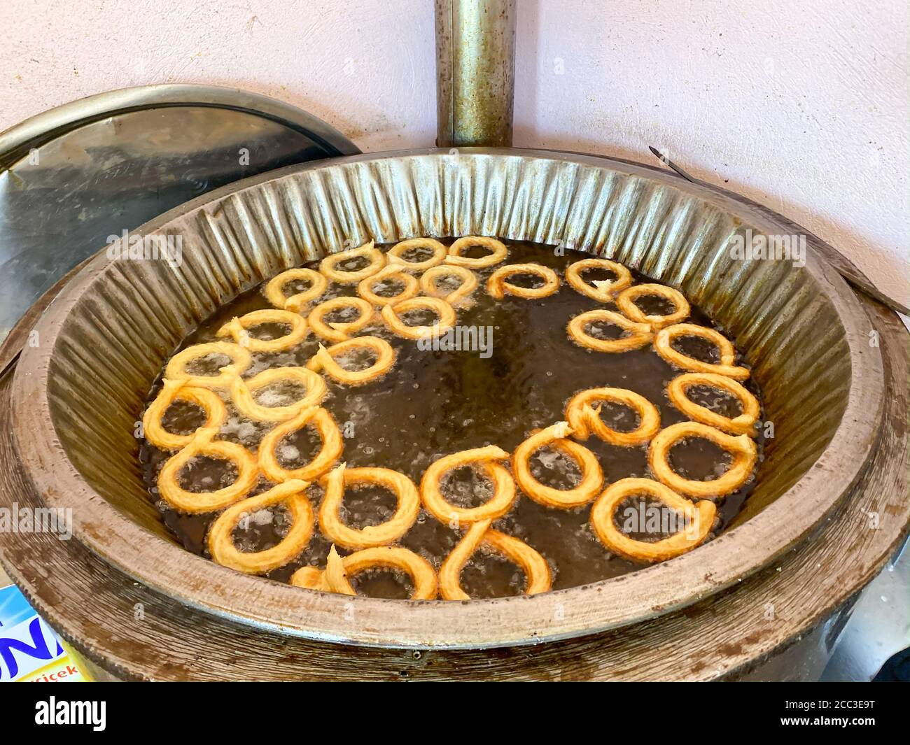 Turkish Dessert Churros Halka Tatli frying in hot oil. Turkish ...