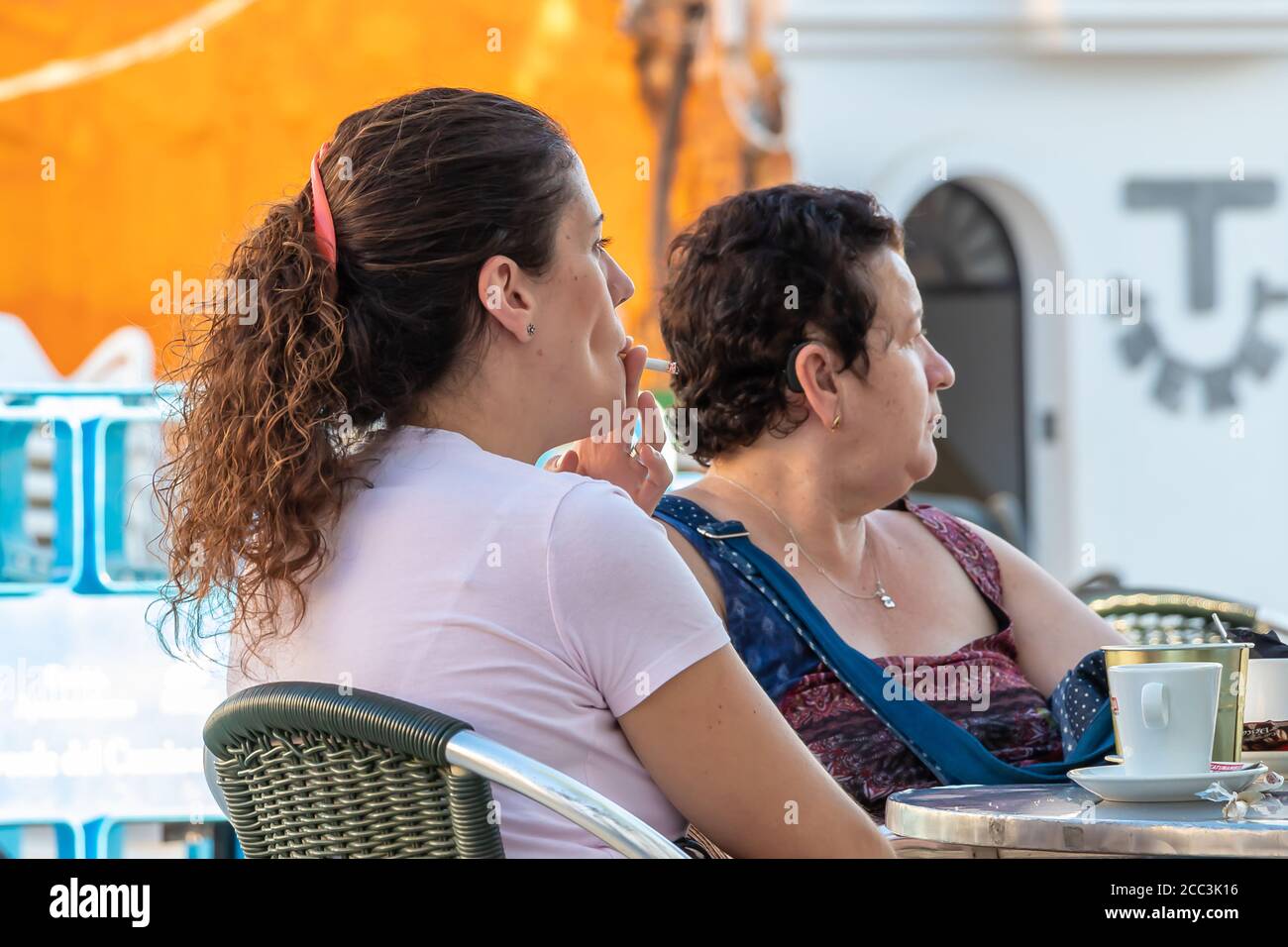 Huelva, Spain - August 17, 2020: woman is smoking a cigarette in a bar ...