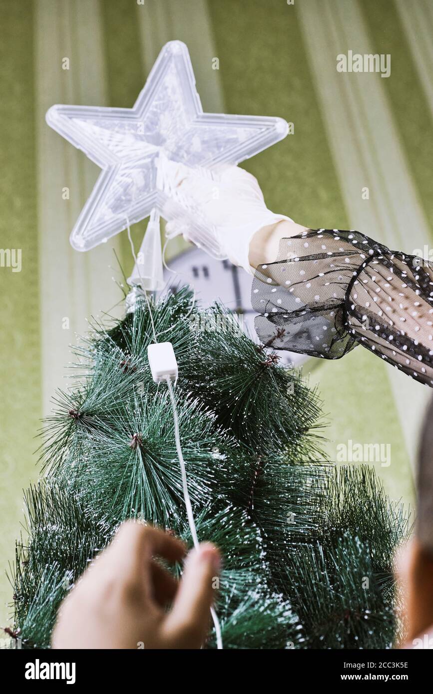 Putting star on christmas tree hi-res stock photography and images - Alamy