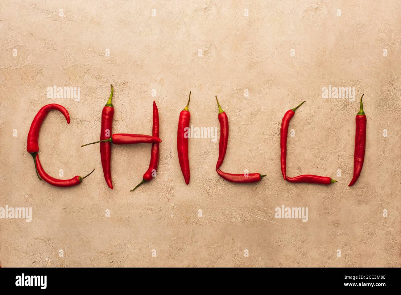 top view of word chilli made of peppers on beige concrete surface Stock ...