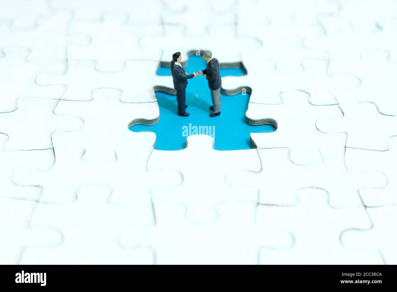 Business strategy conceptual photo - two miniature businessman make ...