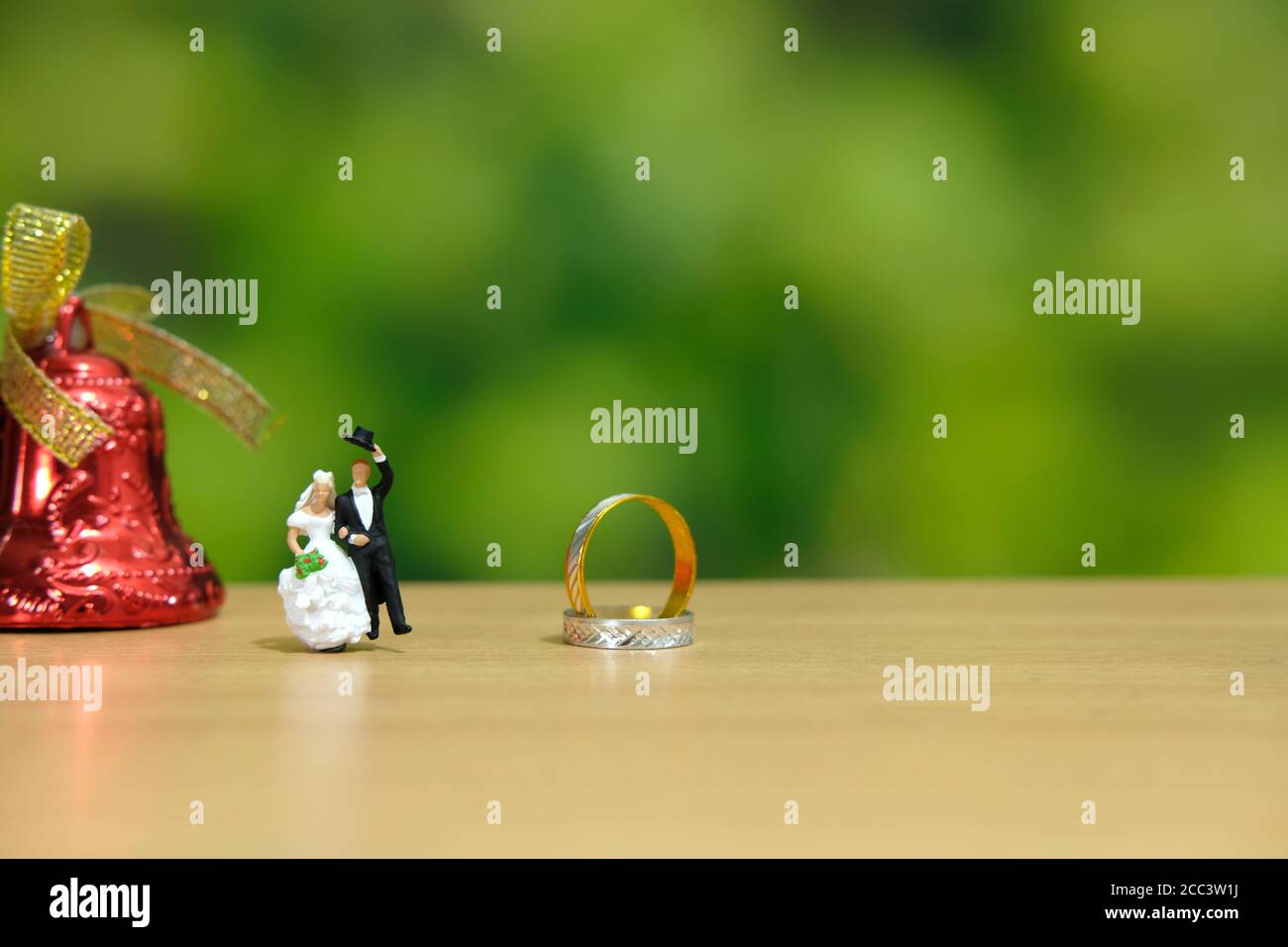 Miniature wedding concept. Bride and groom make greeting. image photo ...