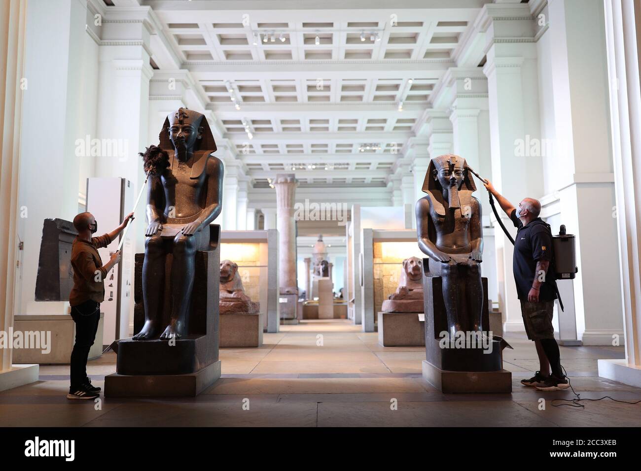 Collection managers Alex Truscott (left) and Evan York dusting statues ...