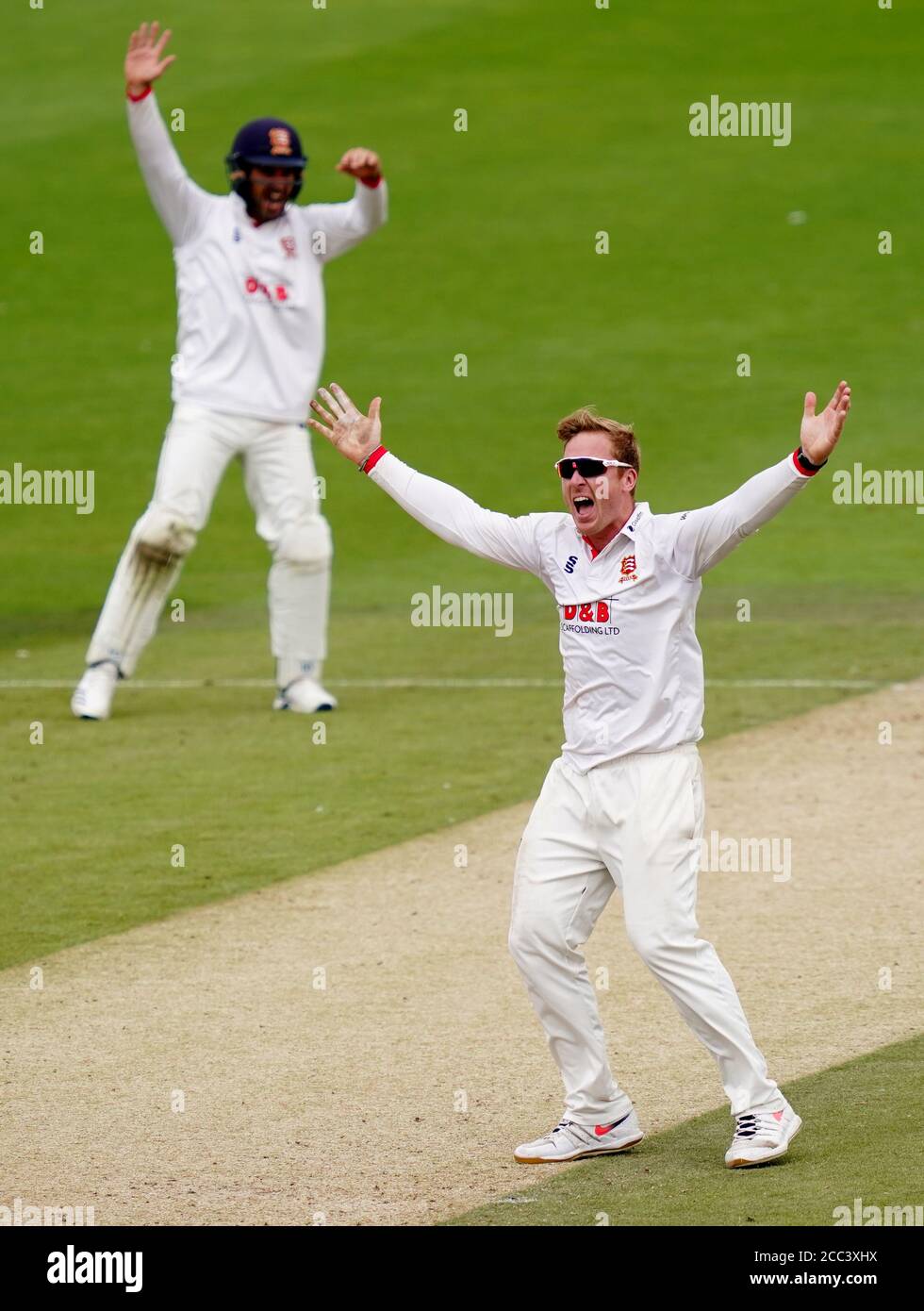 Essex's Simon Harmer (right) celebrates the wicket of Sussex's George ...