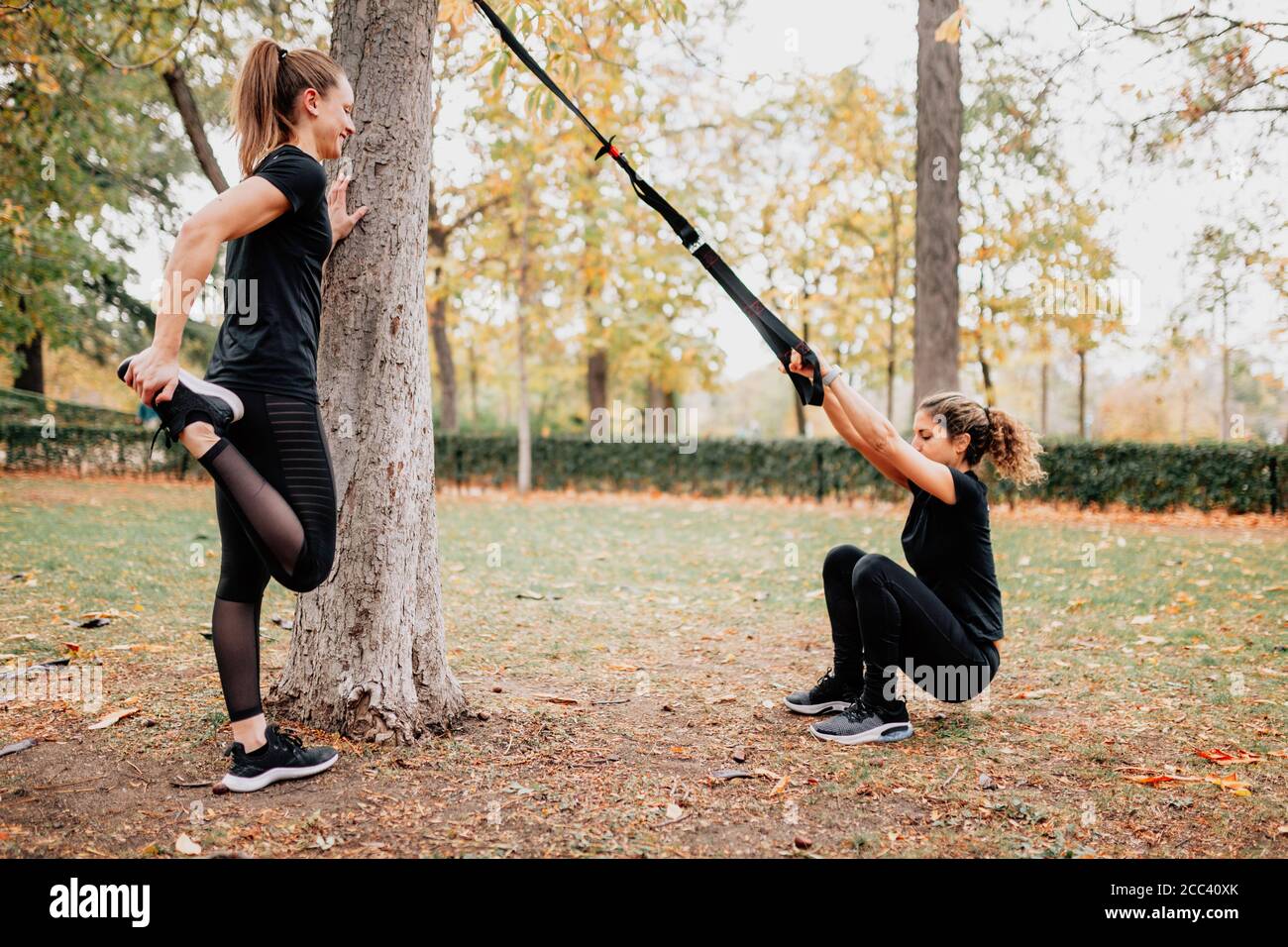 Woman training outside trx hi-res stock photography and images - Alamy