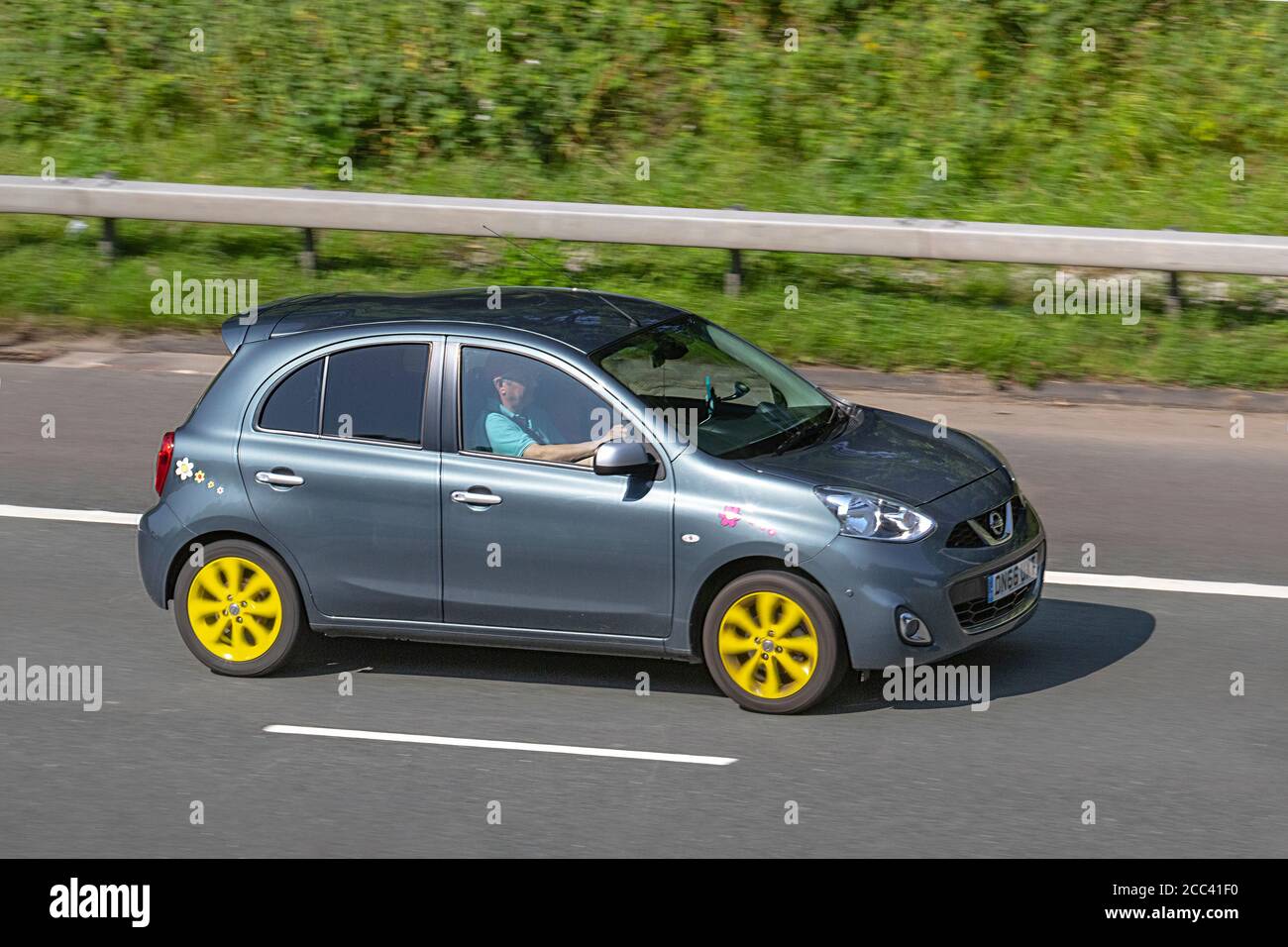 2016 grey Nissan Micra with yellow wheels; Vehicular traffic moving ...