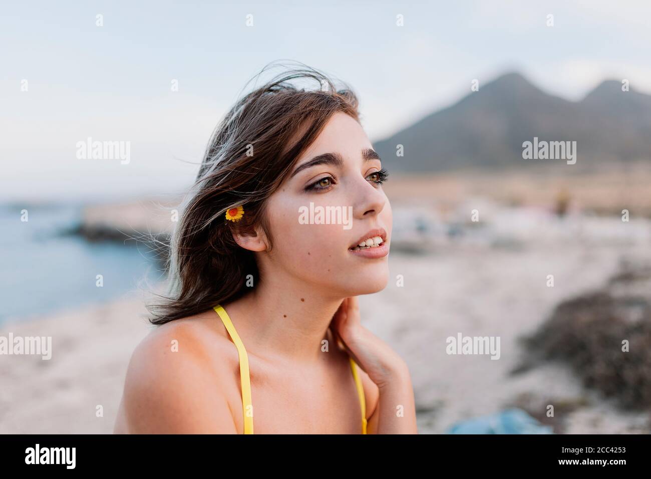 Woman in the beach wearing yellow swimsuit Stock Photo - Alamy