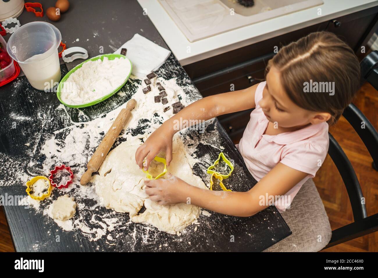 Little is plating with dough, she is making cookies in kitchen Stock ...