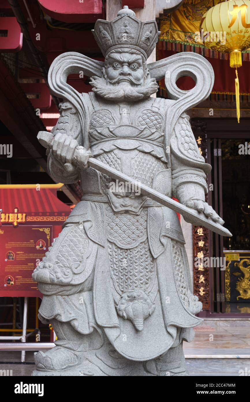 The fierce looking stone figure of a Chinese temple guardian at Jui Tui ...