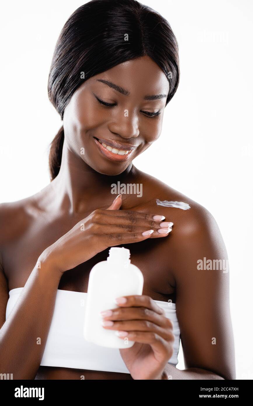 African American Woman Applying Body Lotion Isolated On White Stock