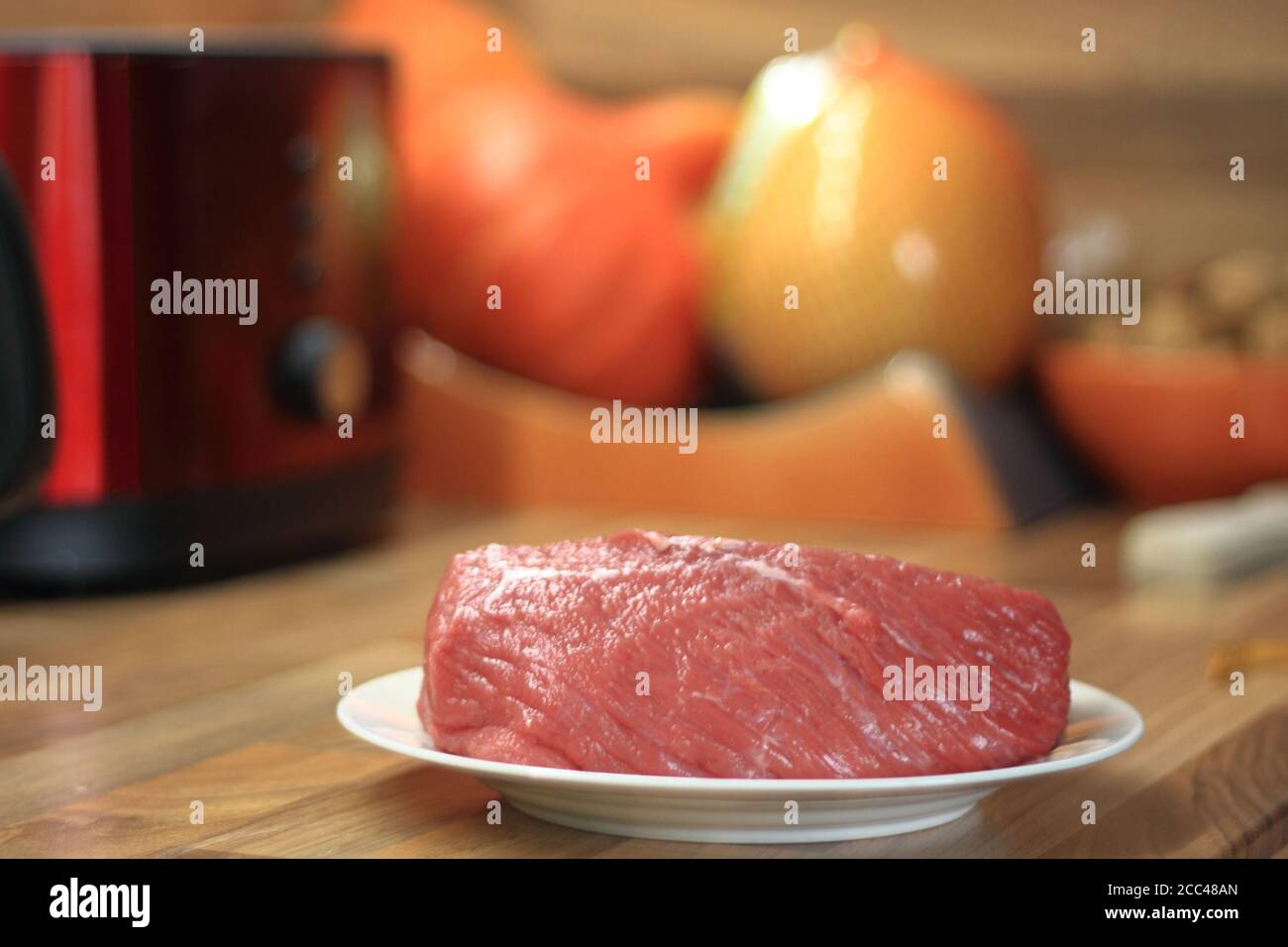raw beef meat with kitchen background Stock Photo - Alamy