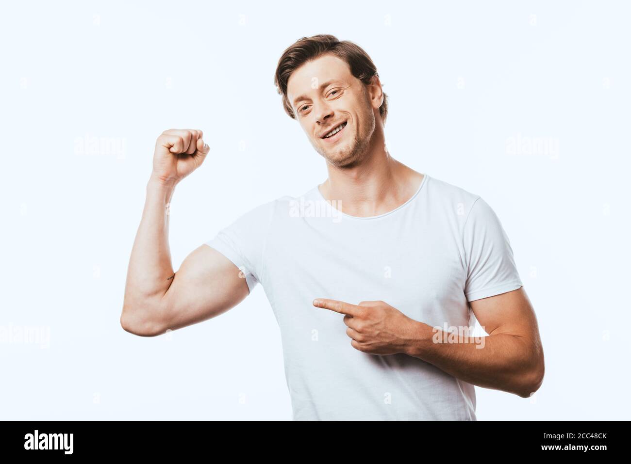 Young man pointing with finger at muscles on hand isolated on white ...