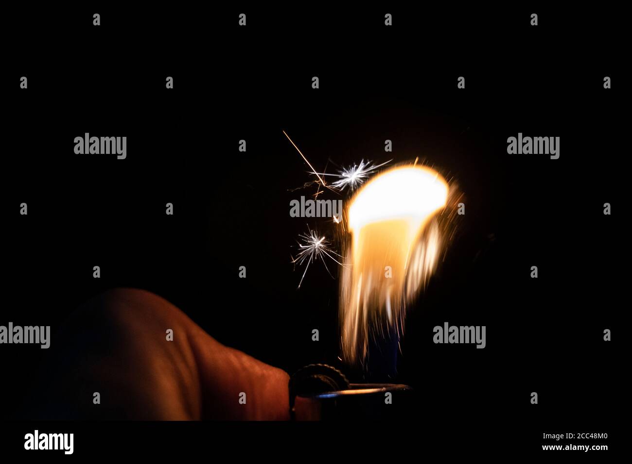fire sparkle on a lighter in black background Stock Photo - Alamy