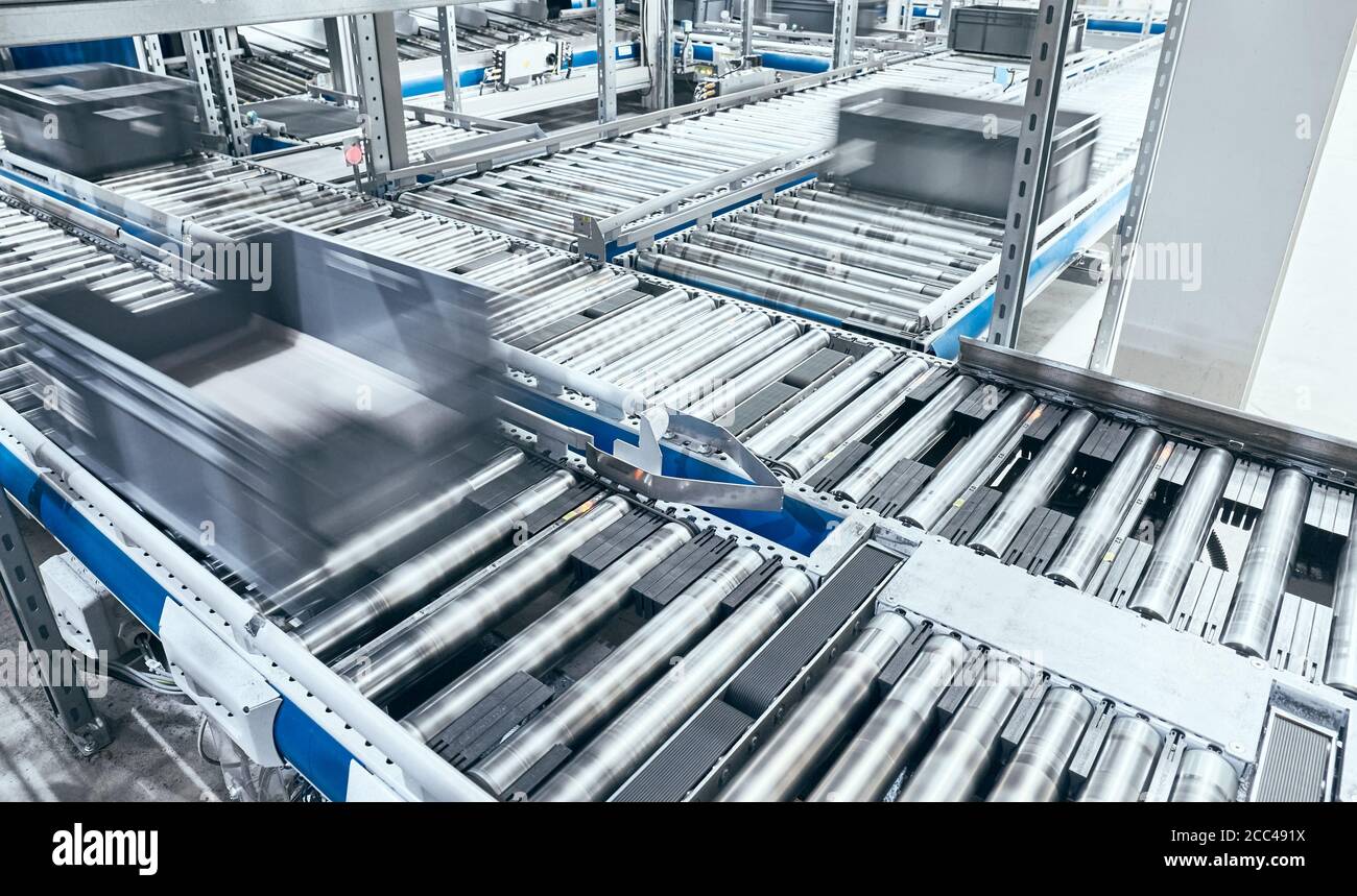 Modern roller conveyor system with boxes in motion, shallow depth of ...