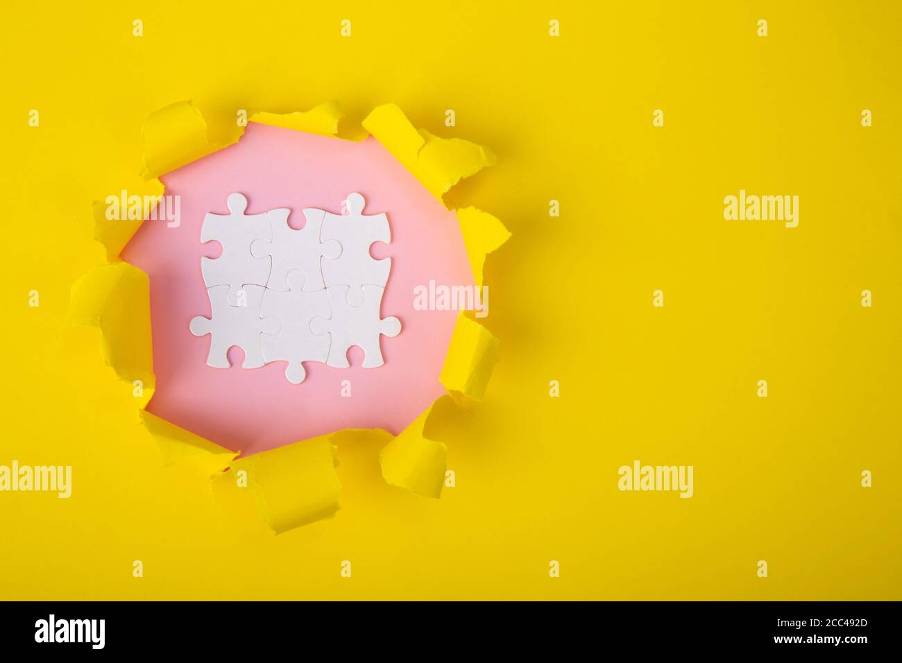 Ripped yellow paper with uncompleted jigsaw puzzle Stock Photo - Alamy