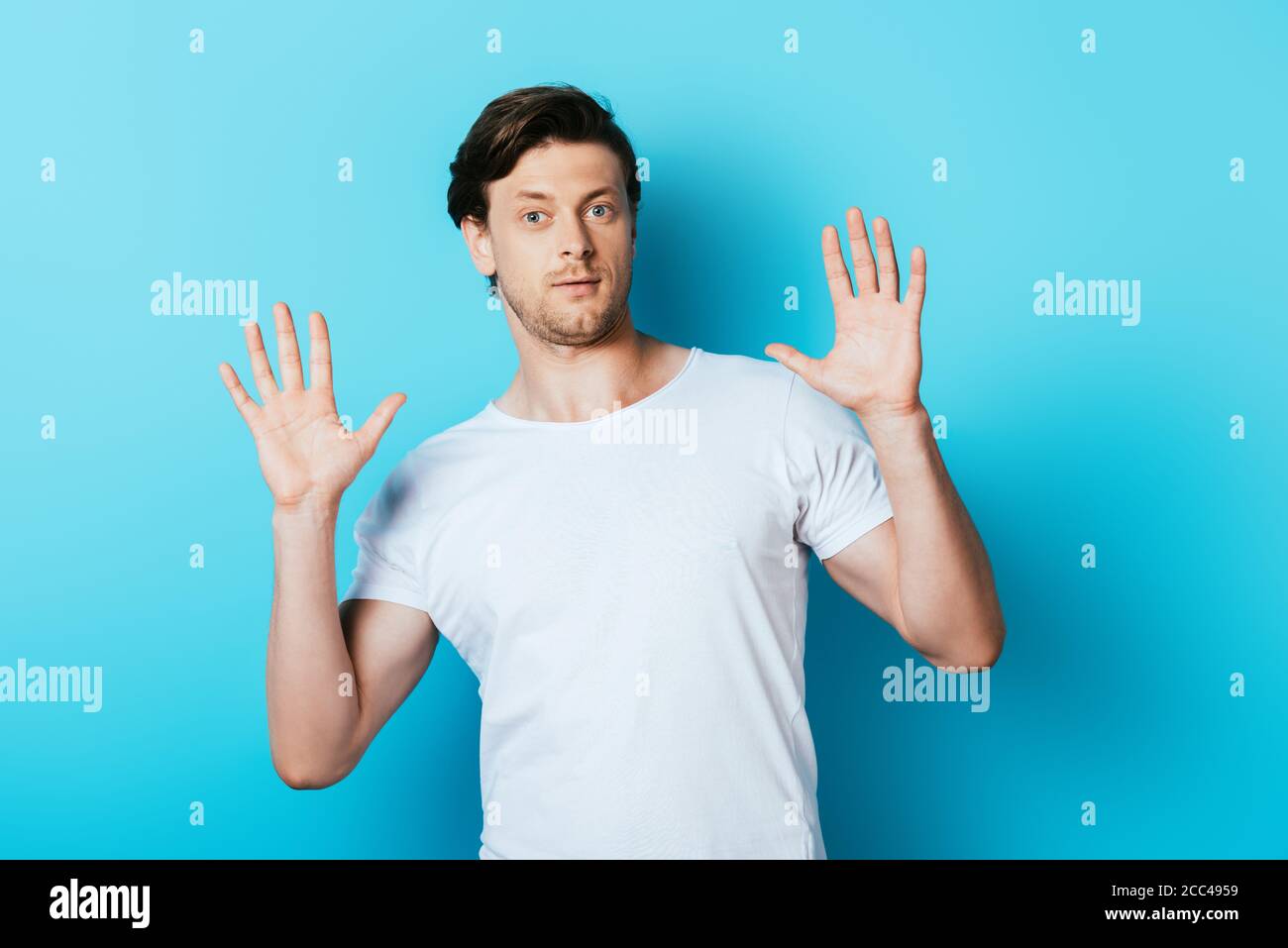 Confused man in white hi-res stock photography and images - Alamy