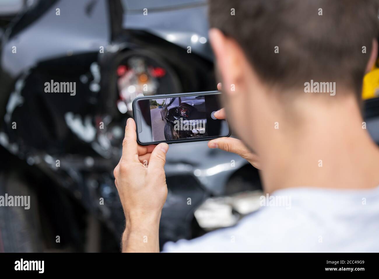 Male Driver Taking Photo Of Damaged Car After Accident For Insurance ...