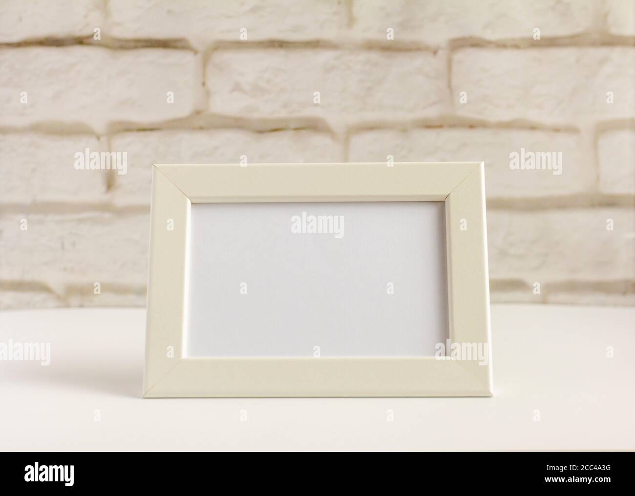 An empty photo frame on a table or shelf with a copy of the space Stock ...