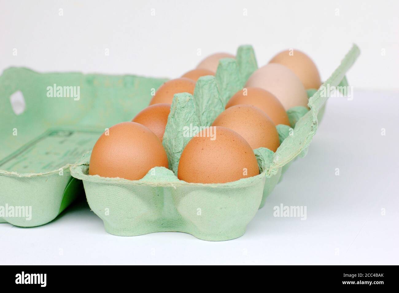 Light green box of chicken eggs on white background Stock Photo - Alamy