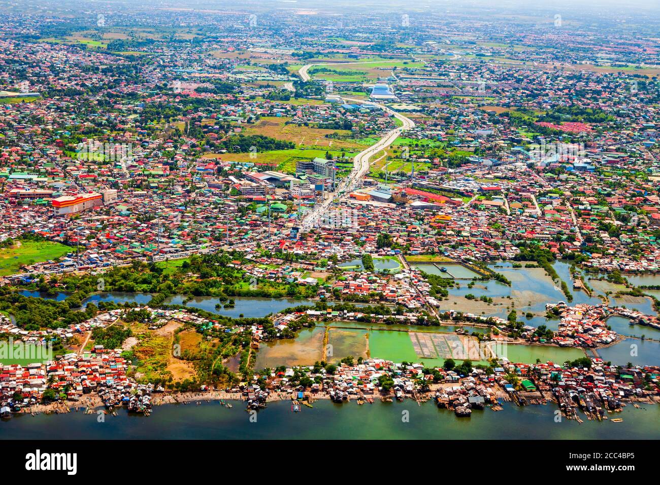Manila suburb with small houses and rice fields aerial panoramic view ...