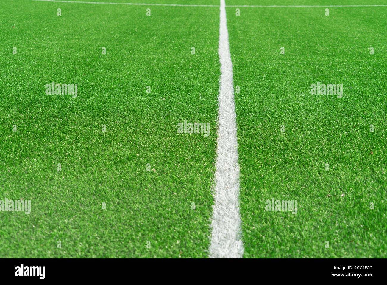 Green artificial grass turf soccer football field background with white ...