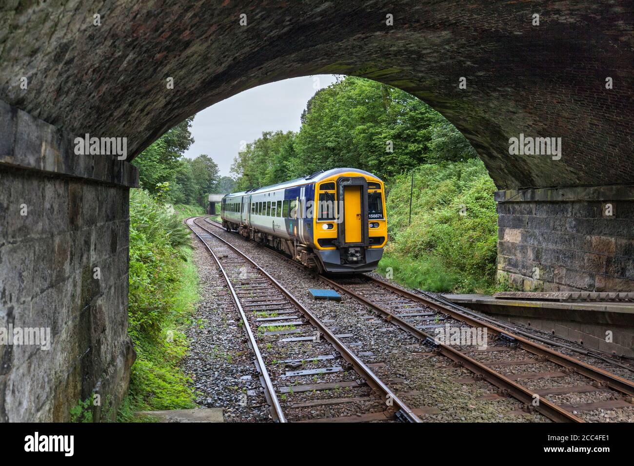 Northern rail class 158 train 158871 passing under a bridge with a ...